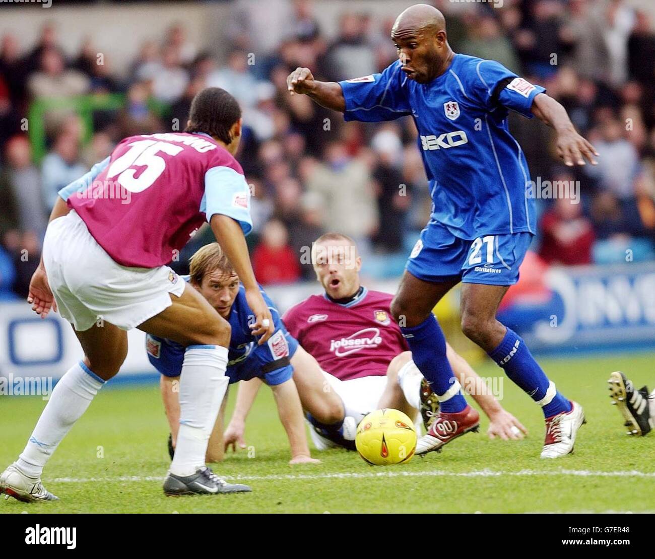 Millwall's Barry Hayles is faced by West Ham United's Anton Ferdinand ...