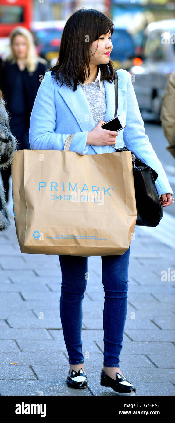 A shopper carries primark bags outside primark in oxford street hi-res ...