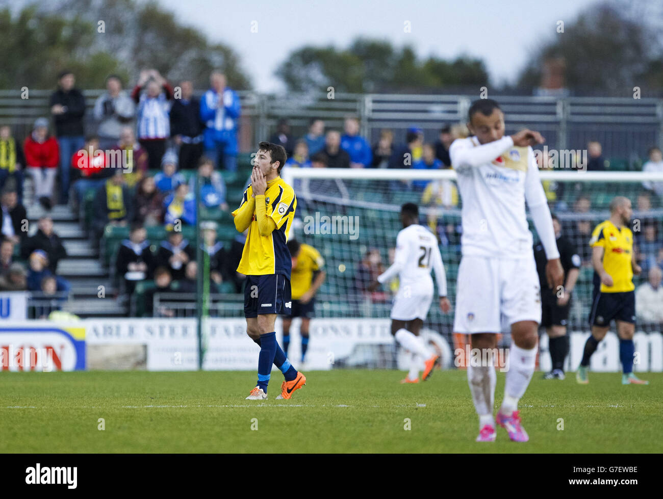 Gosport Boroughs Dan Wooden (in yellow) reacts as another goal goes in ...