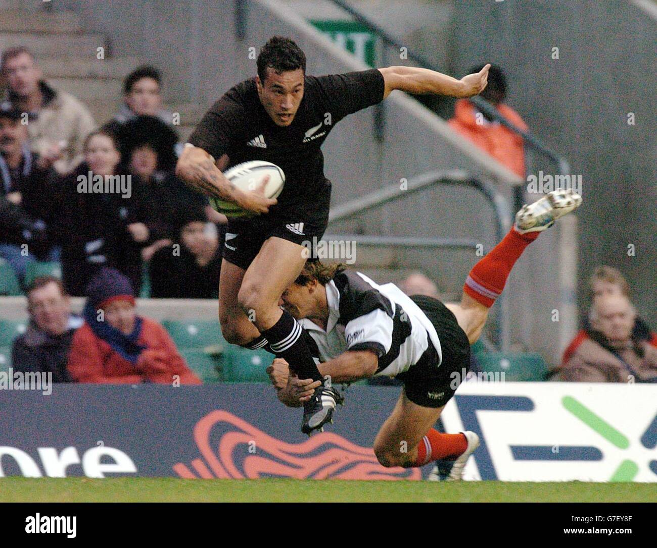 New Zealand's Rico Gear skips out of a tackle by Barbarian's full back ...