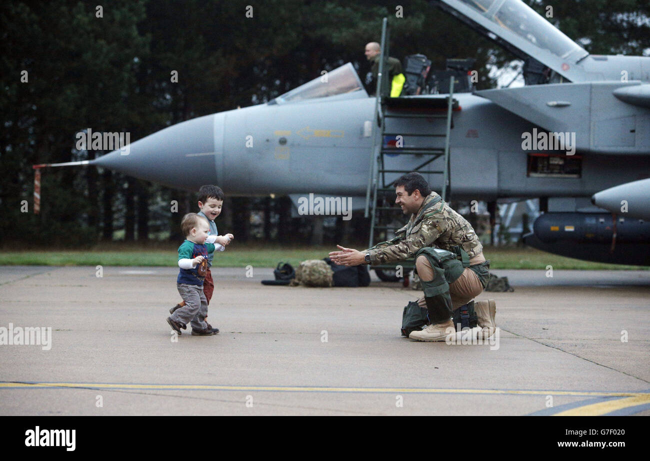 Squadron Leader Gareth Prendergast is greeted by his sons Hector, 3 and ...