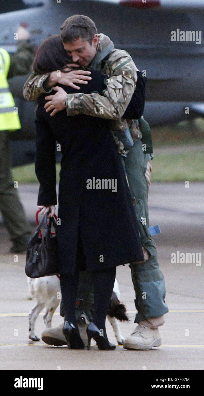 Flight Lieutenant Oliver Payne is greeted by his partner Liza Brooks ...
