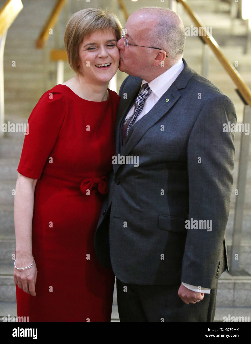 SNP leader Nicola Sturgeon is given a kiss by her husband Peter Murrell ...