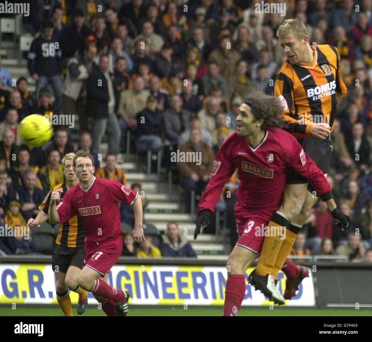 Hull's Danny Allsopp (top) heads past Walsall's Zigor Aranalde (front ...