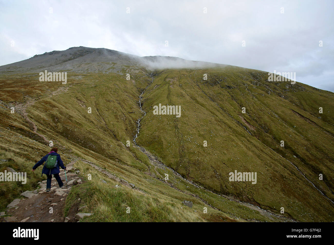 A hiker descending the 'Mountain Track' path of Britain's tallest ...