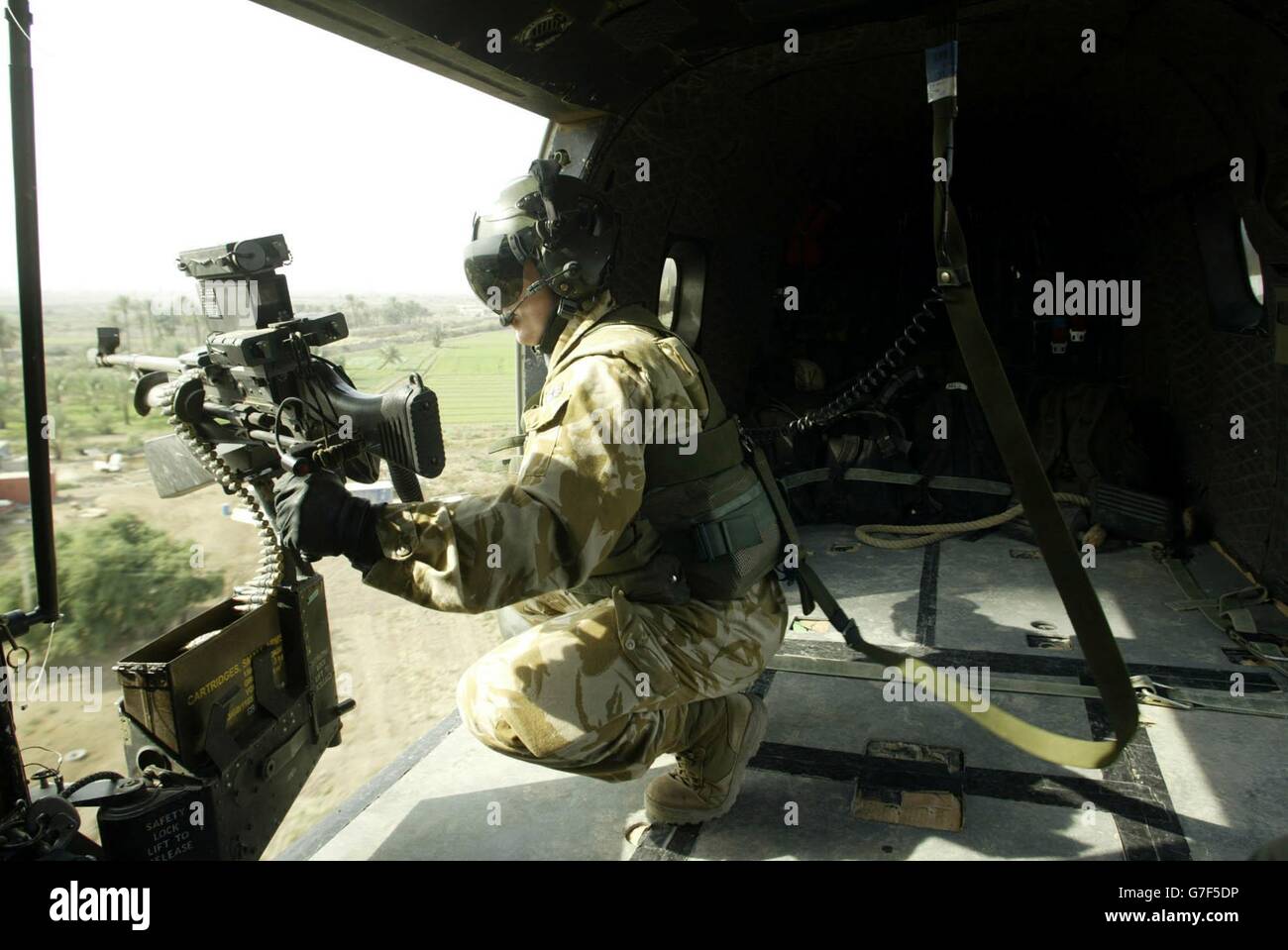 OVERSEAS USE ONLY: The Gunner of an RAF Puma helicopter scans the ...