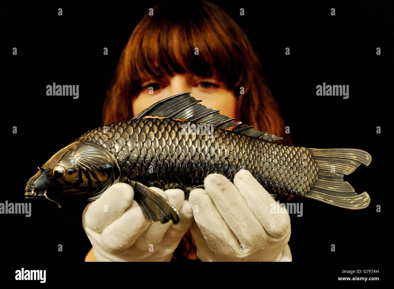 Bonhams staff member Danielle DeMartini holds a pure silver articulated ...