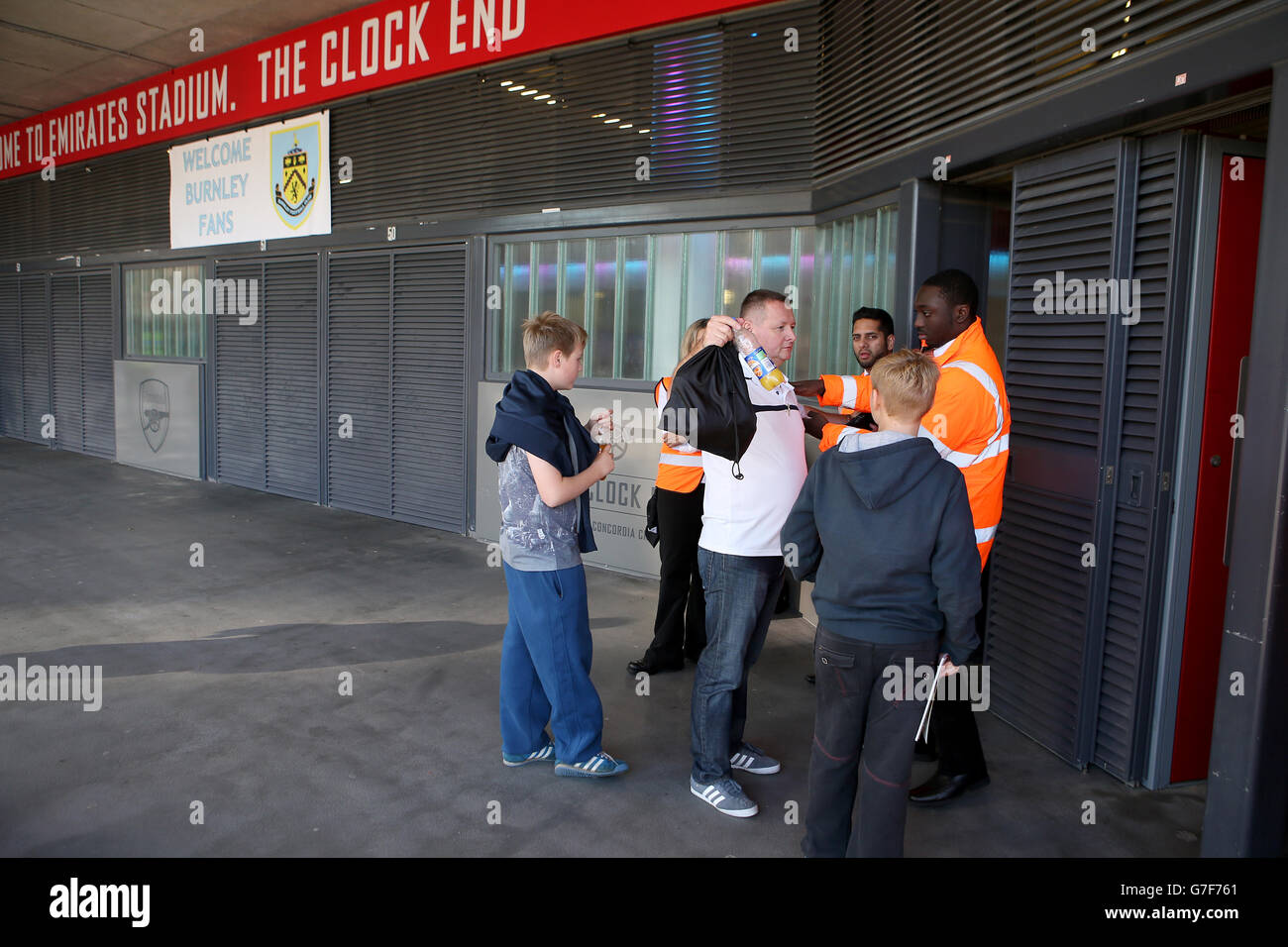 Fans go through security checks at the turnstiles of the Emirates ...