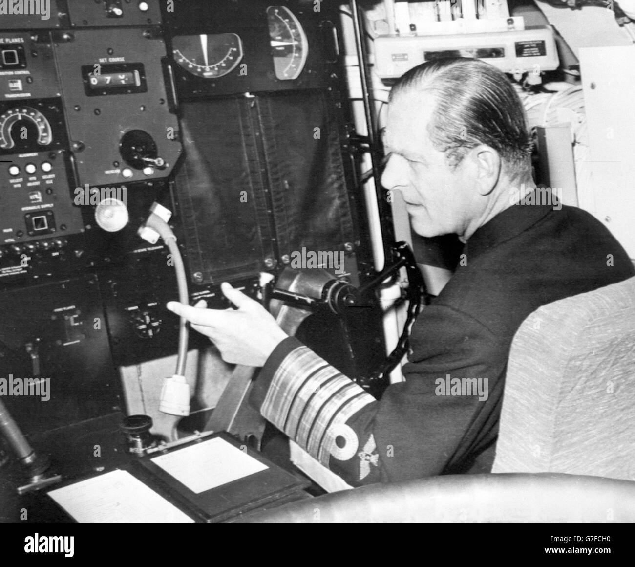 The Duke of Edinburgh, in uniform of the Admiral of the Fleet, sits at ...
