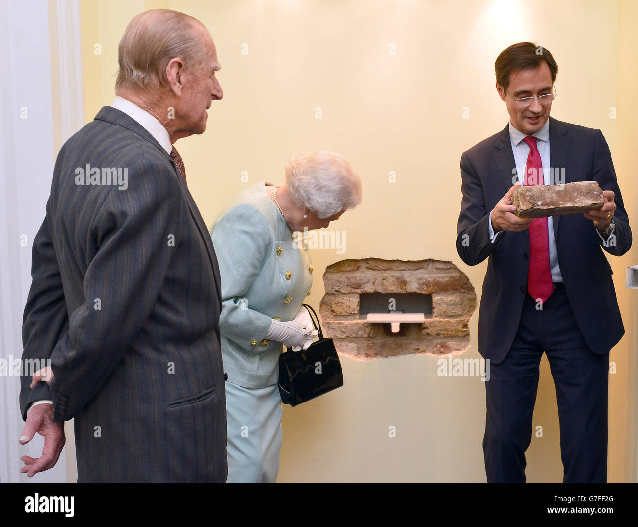 The Duke of Edinburgh looks on as Queen Elizabeth II and Dr Robin ...