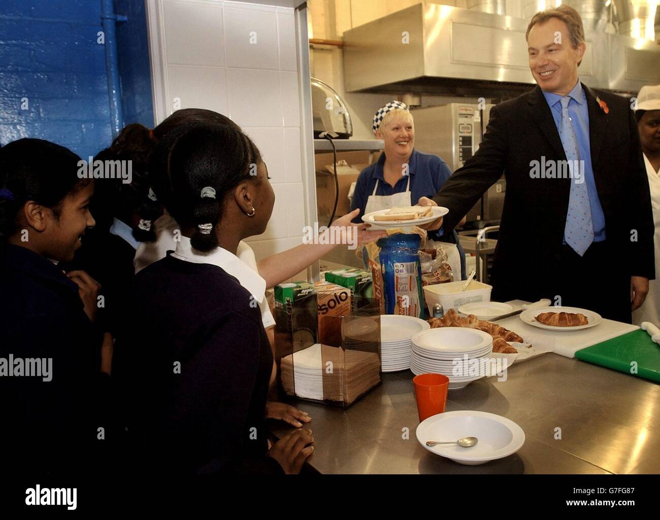 Prime Minister Tony Blair serves breakfast to pupils at Millfields ...