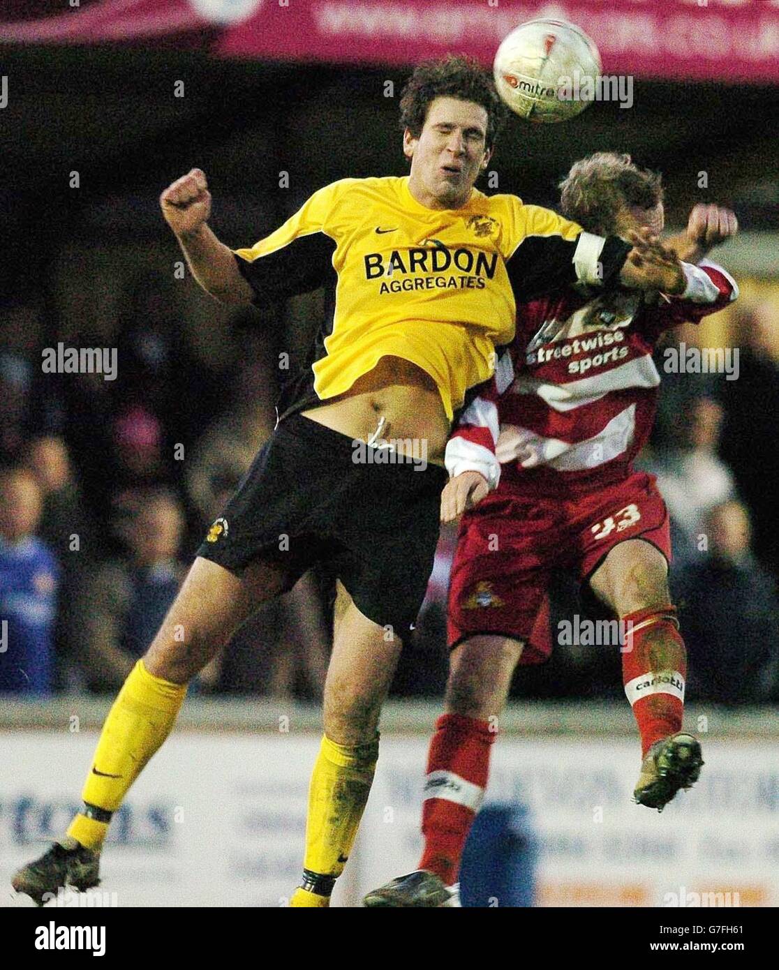 Nathan Rudge of Tiverton (left) tussles with Neil Roberts of Doncaster ...
