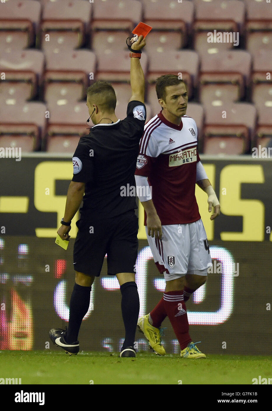 Fulham's Ross McCormack (right) is shown a red card by referee James ...