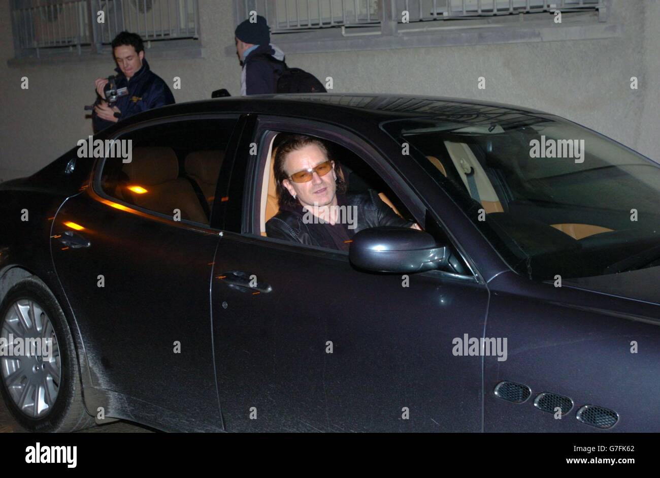 Singer Bono from Irish rock band U2, signs autographs for fans outside ...