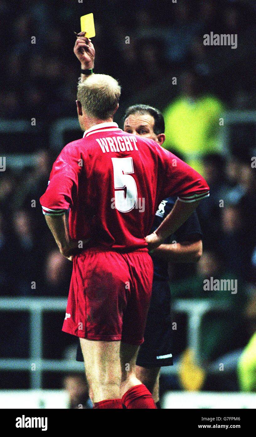 Mark Wright, Liverpool is shown the yellow card by the referee Steve ...