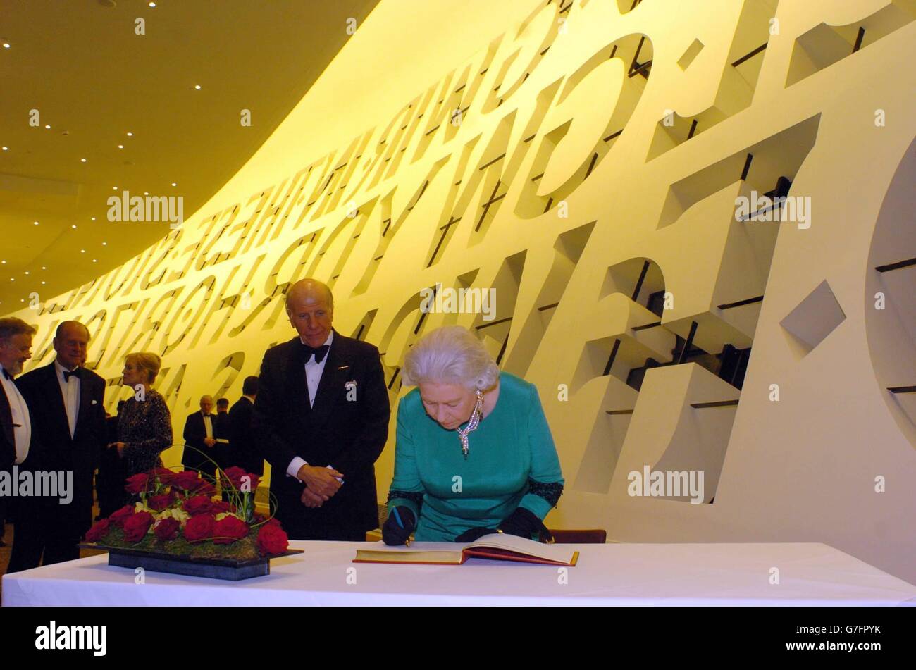 The Queen signs the visitors' book at the Royal Gala concert at the ...