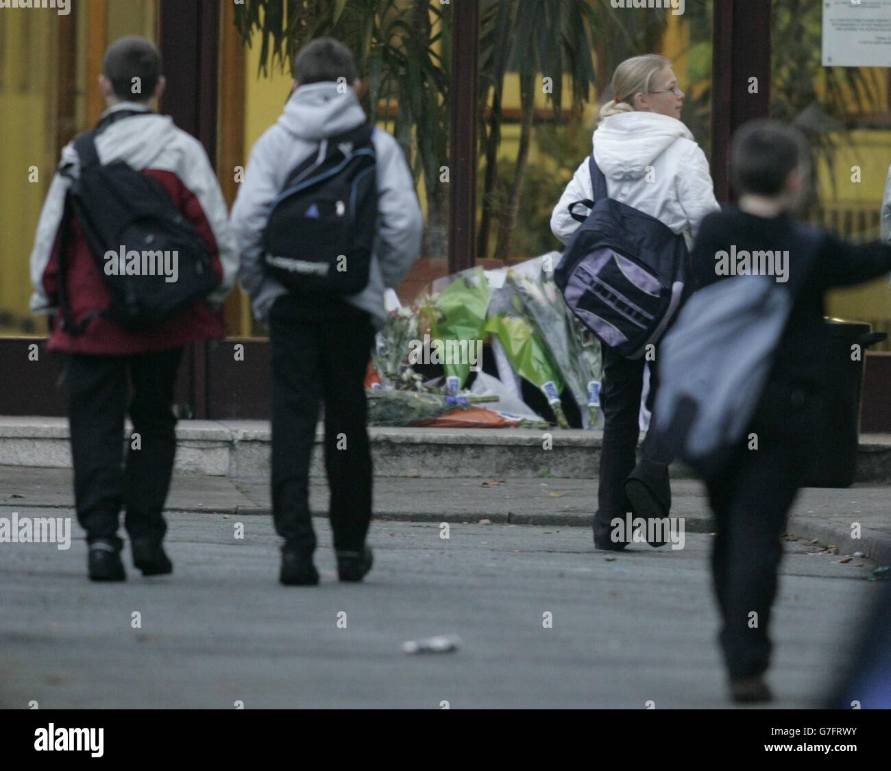 Pupils look at floral tributes left outside Broadoak High School in ...