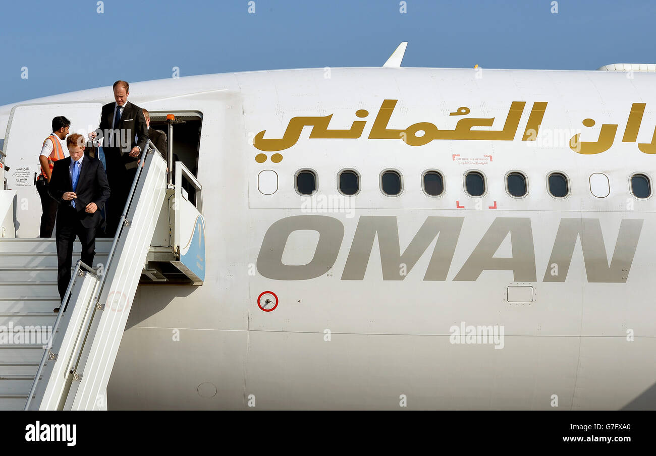 Prince Harry walks down the steps of an Oman Air jet in Muscat, Oman ...