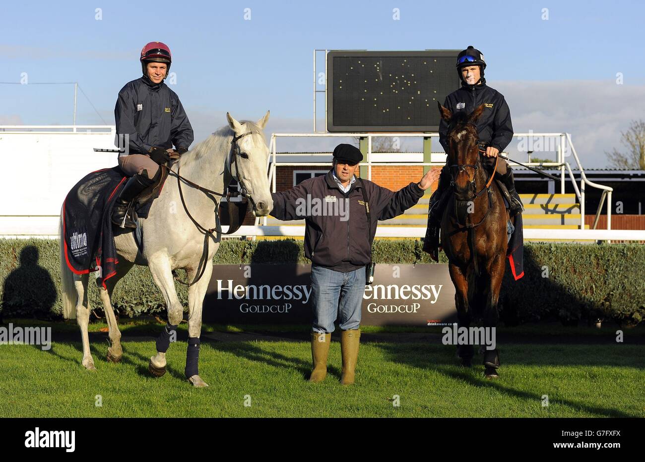 Trainer Alan King (centre) poses with his horses Smad Place (left) and ...