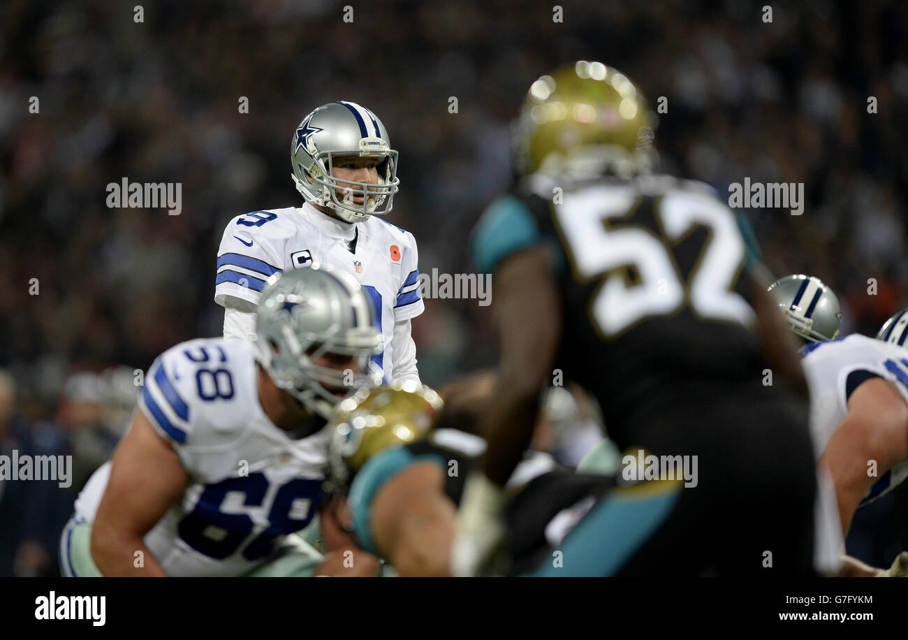 Dallas Cowboys' quarterback Tony Romo (left) looks on before a play ...