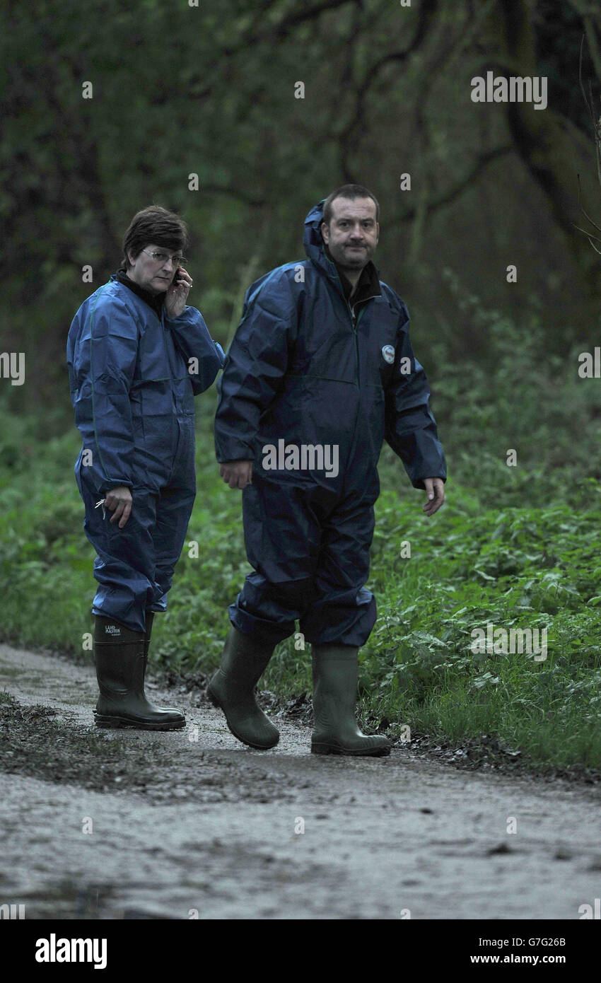 Defra staff in protective clothing on a farm in Nafferton, East ...