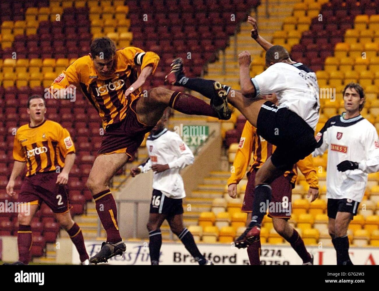 Bradford City's David Weatherall (left) challenges Walsall's Julian ...