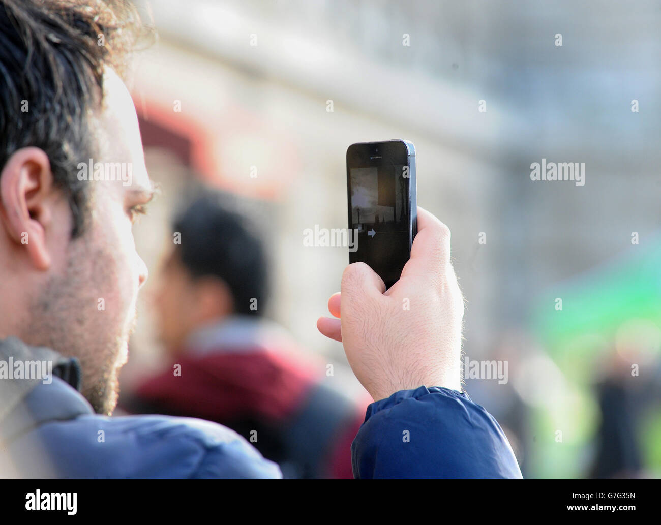 A generic stock photo of a man taking a picture using his mobile phone ...