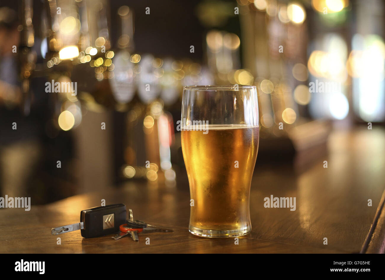 A pint of beer and a set of car keys on a bar in a pub in central ...