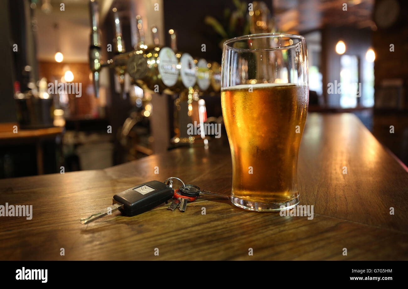 A pint of beer and a set of car keys on a bar in a pub in central ...