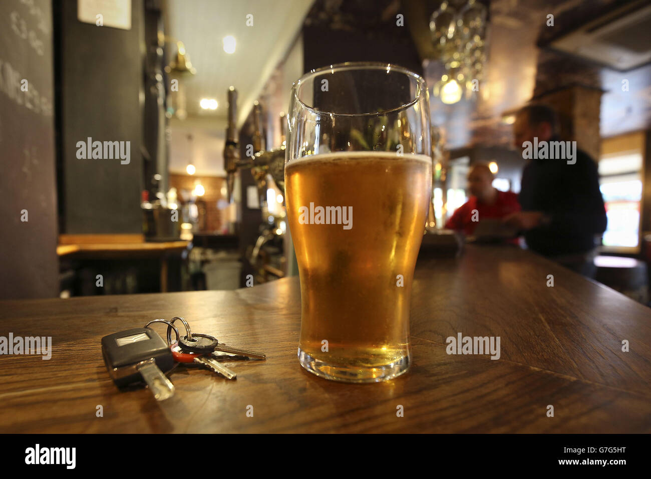 A pint of beer and a set of car keys on a bar in a pub in central ...
