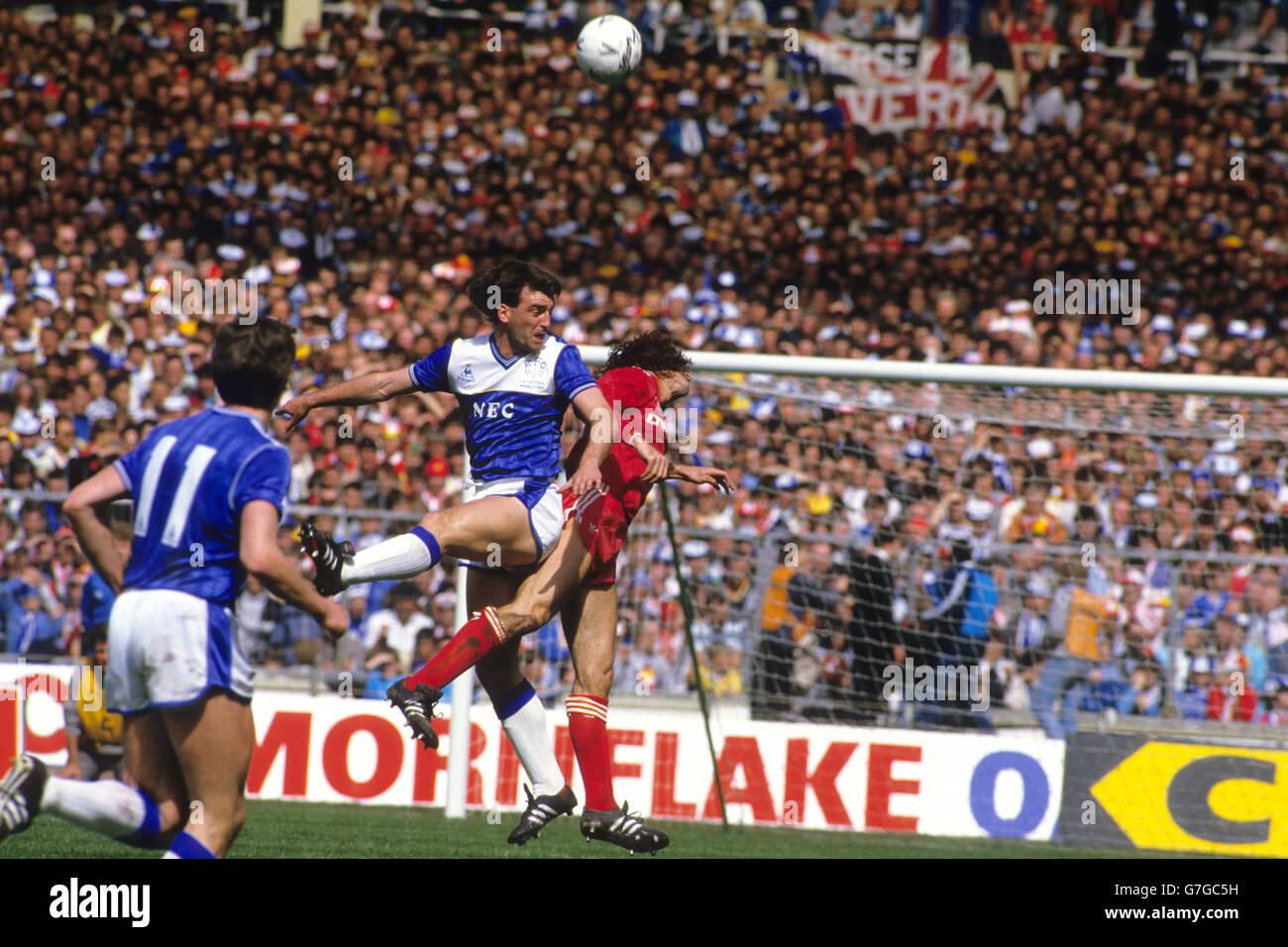 Everton's Kevin Ratcliffe competes for a header with Liverpool's Craig ...