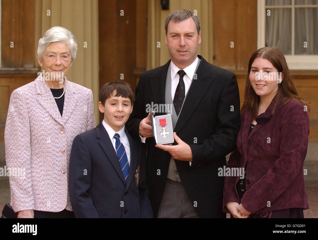 Garth mcgimpsey smiles proudly as he holds his mbe hi-res stock ...