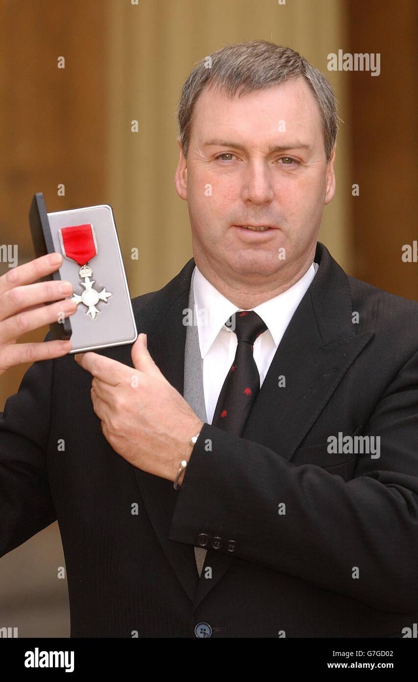 Garth mcgimpsey smiles proudly as he holds his mbe hi-res stock ...