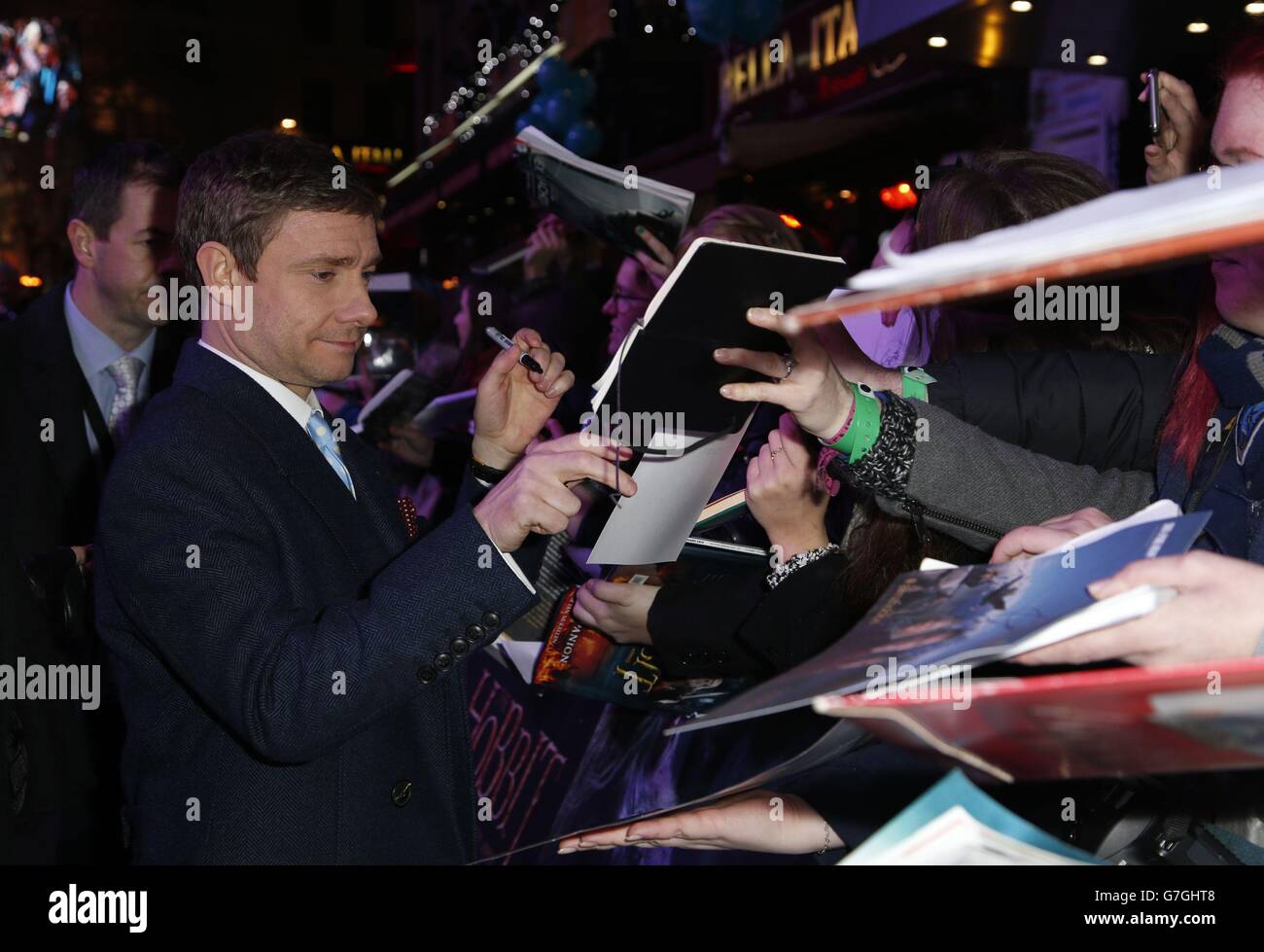 Martin Freeman signs autographs as he arrives on the green carpet for ...