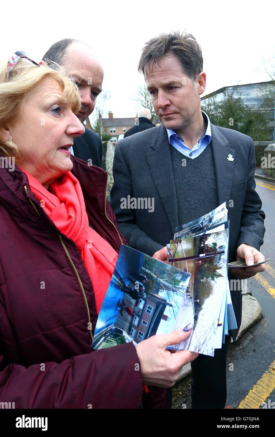 Deputy Prime Minister Nick Clegg looks at photographs of flood damage ...