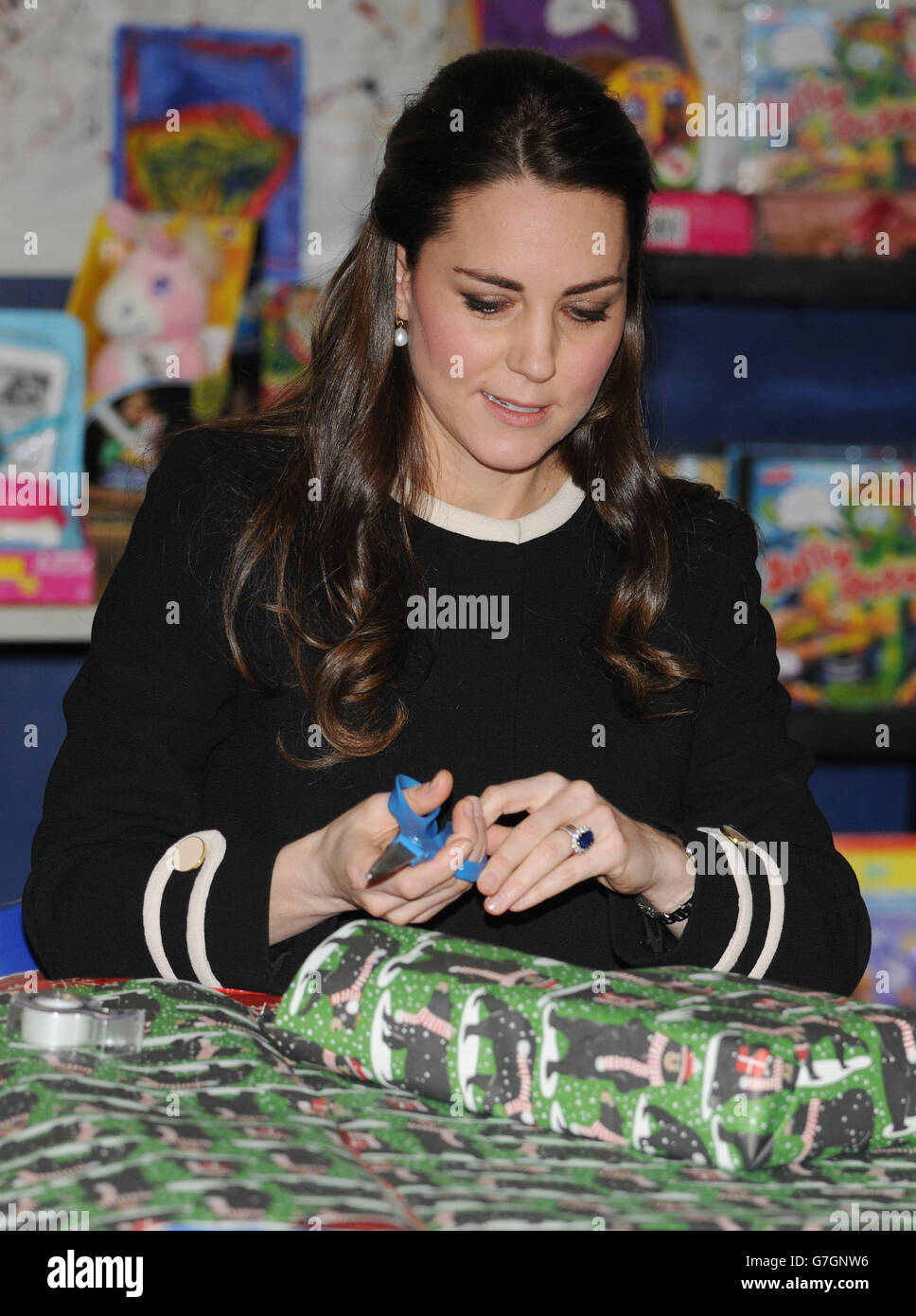 The Duchess of Cambridge helps wrap Christmas presents during a visit ...