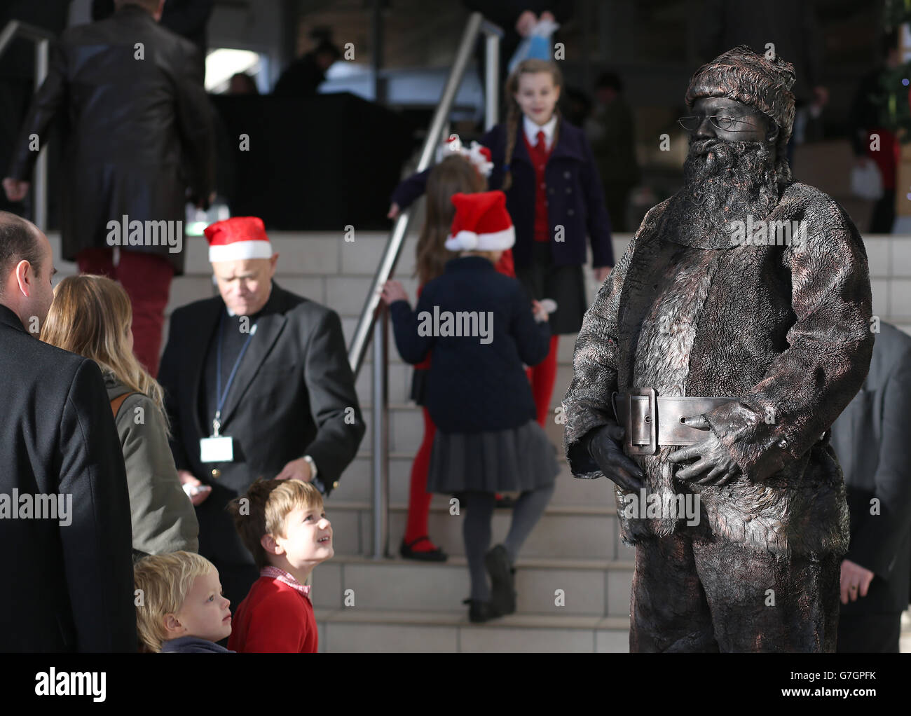 People look at a bronze Santa human statue in the entrance foyer at ...