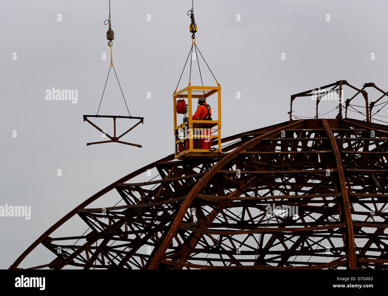 Demolition specialists cut through the steel carcass of Eastbourne Pier ...