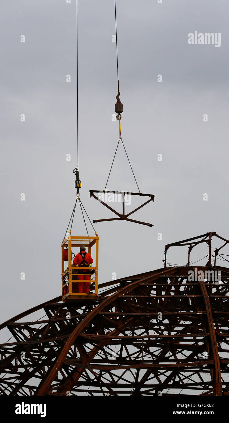 Demolition specialists cut through the steel carcass of Eastbourne Pier ...