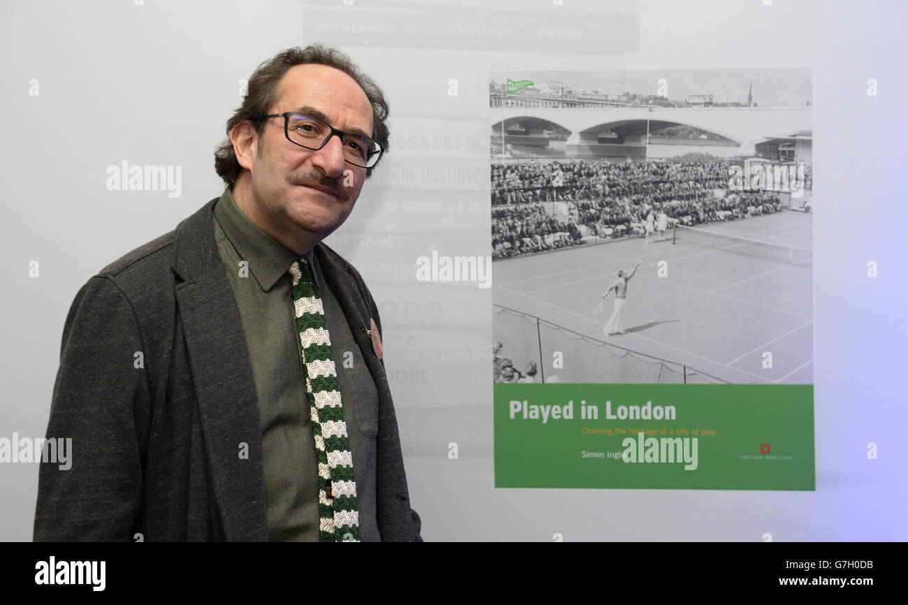 Simon Inglis poses alongside a print for his book 'Played in London ...