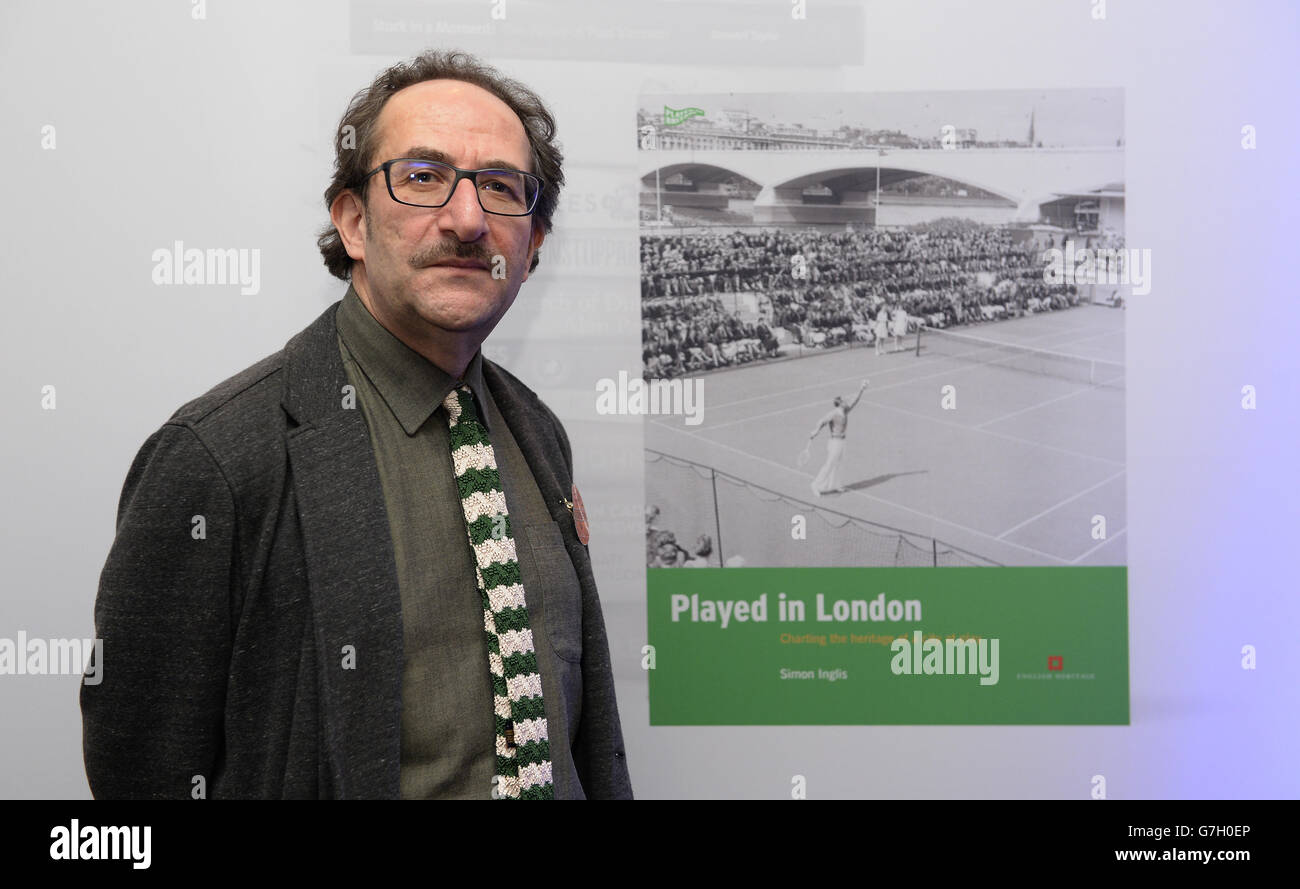 Simon Inglis poses alongside a print for his book 'Played in London ...