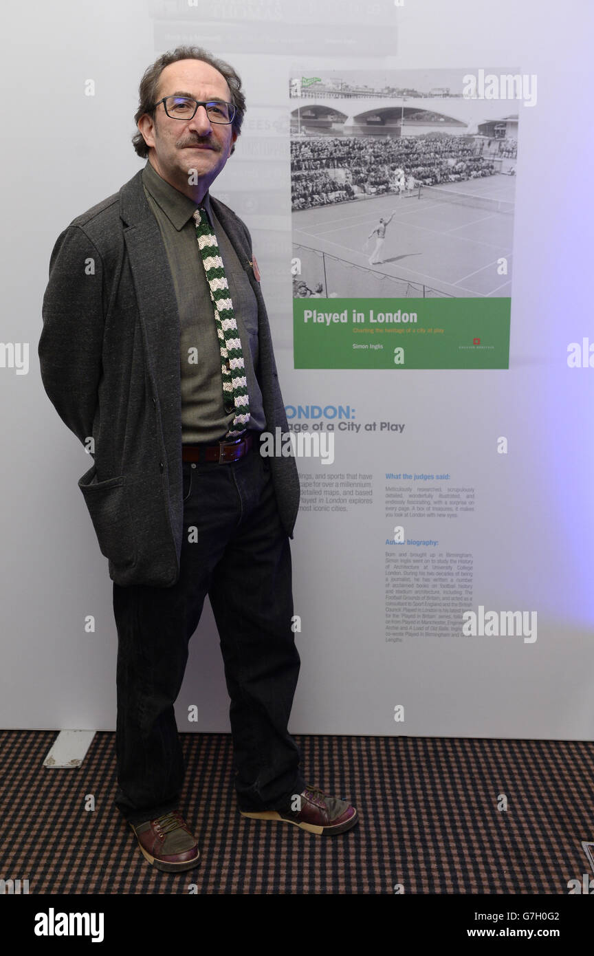 Simon Inglis poses alongside a print for his book 'Played in London ...