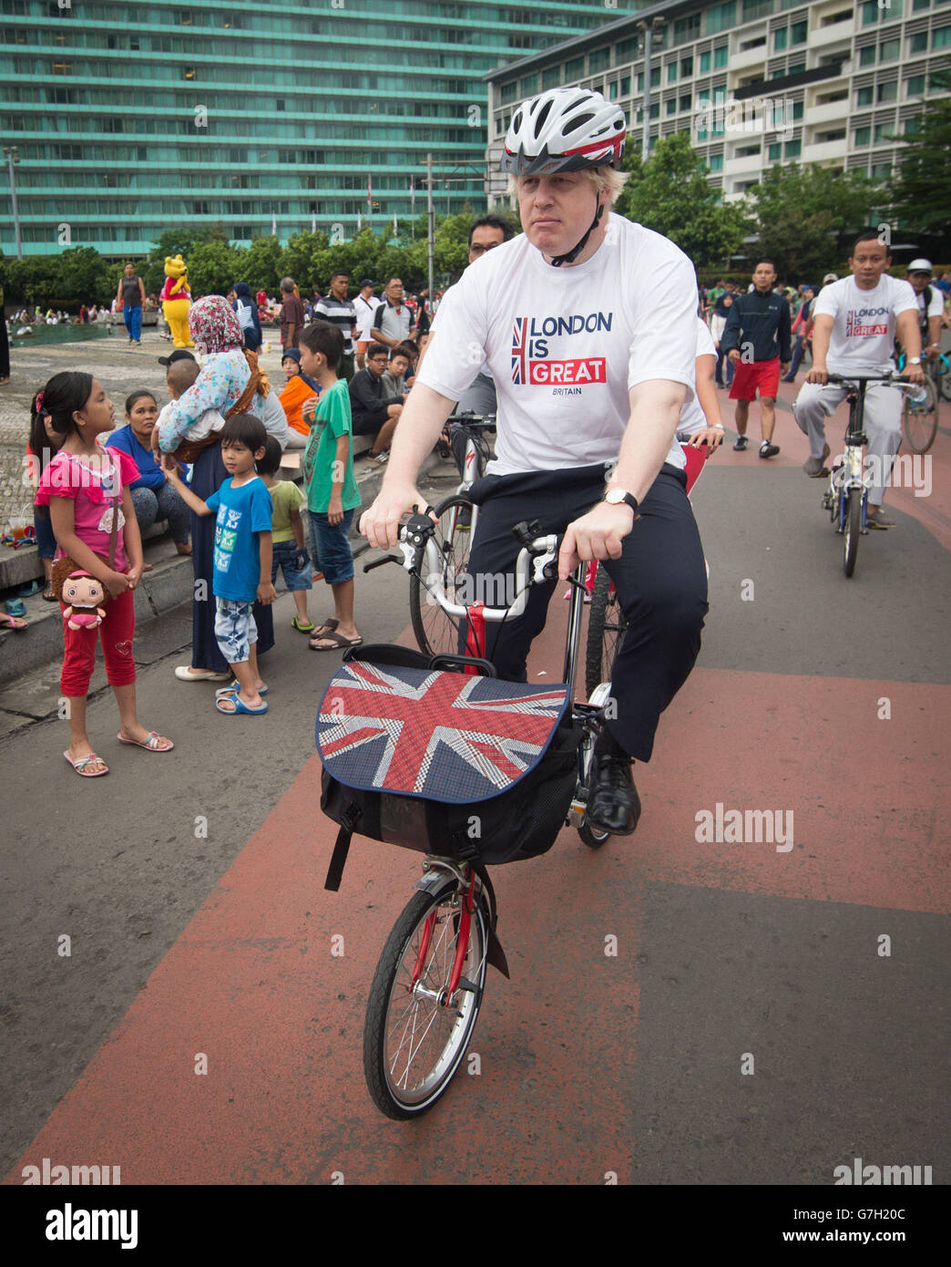 Mayor of London Boris Johnson cycles through the streets of Jakarta on ...