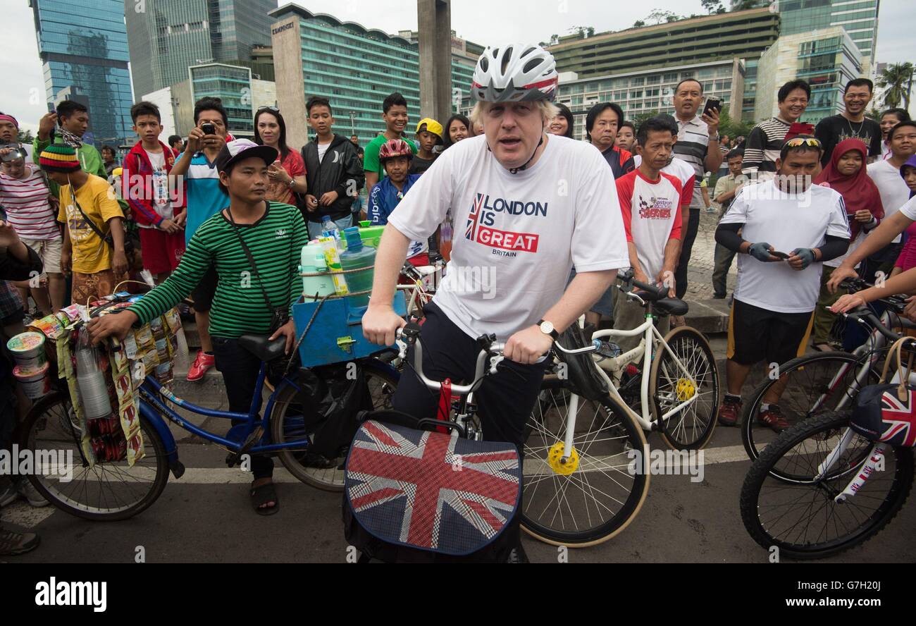 Mayor of London Boris Johnson cycles through the streets of Jakarta on ...