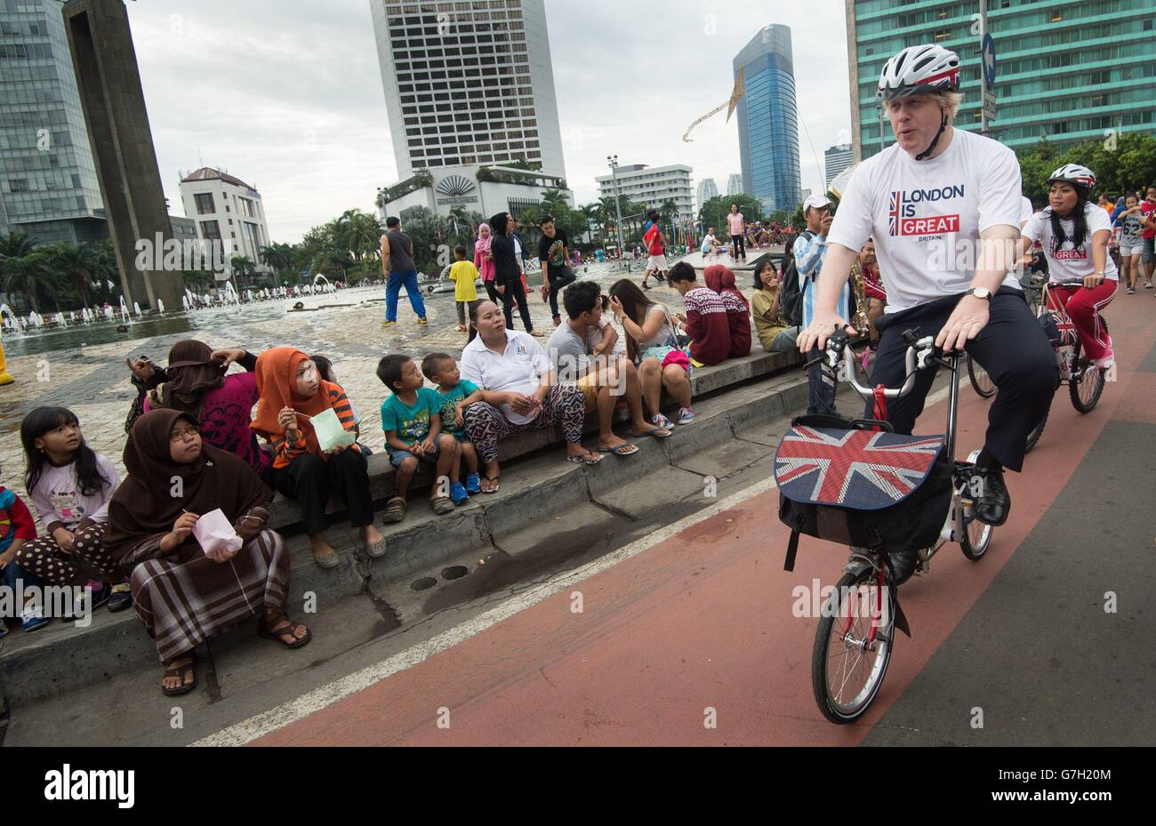 Mayor of London Boris Johnson cycles through the streets of Jakarta on ...