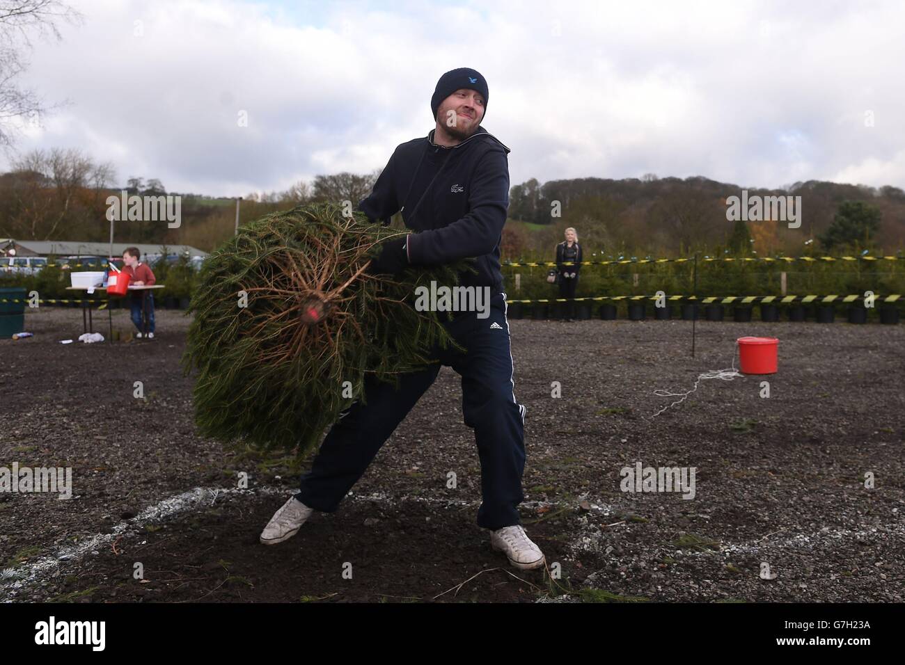A competitor takes part in The UK Christmas Tree Throwing Championships ...