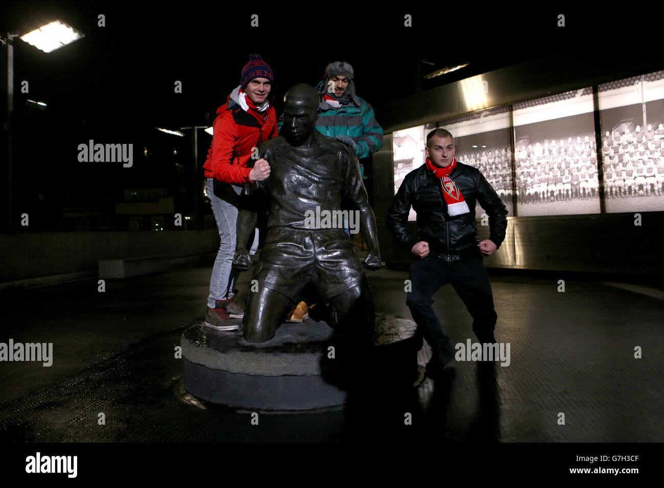 A night-time view of Arsenal fans at the Thierry Henry statue outside ...