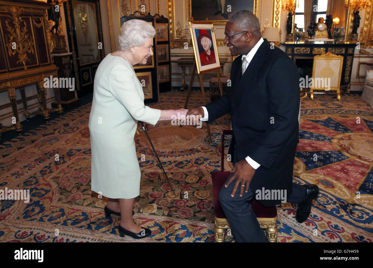 Queen Elizabeth II knights Sir Rodney Williams upon his appointment as ...