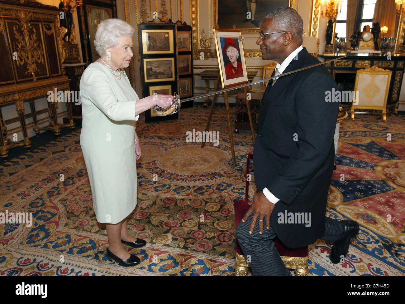 Queen Elizabeth II knights Sir Rodney Williams upon his appointment as ...