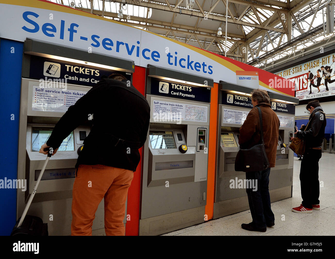 Train passengers buy their tickets at Waterloo Station in central ...